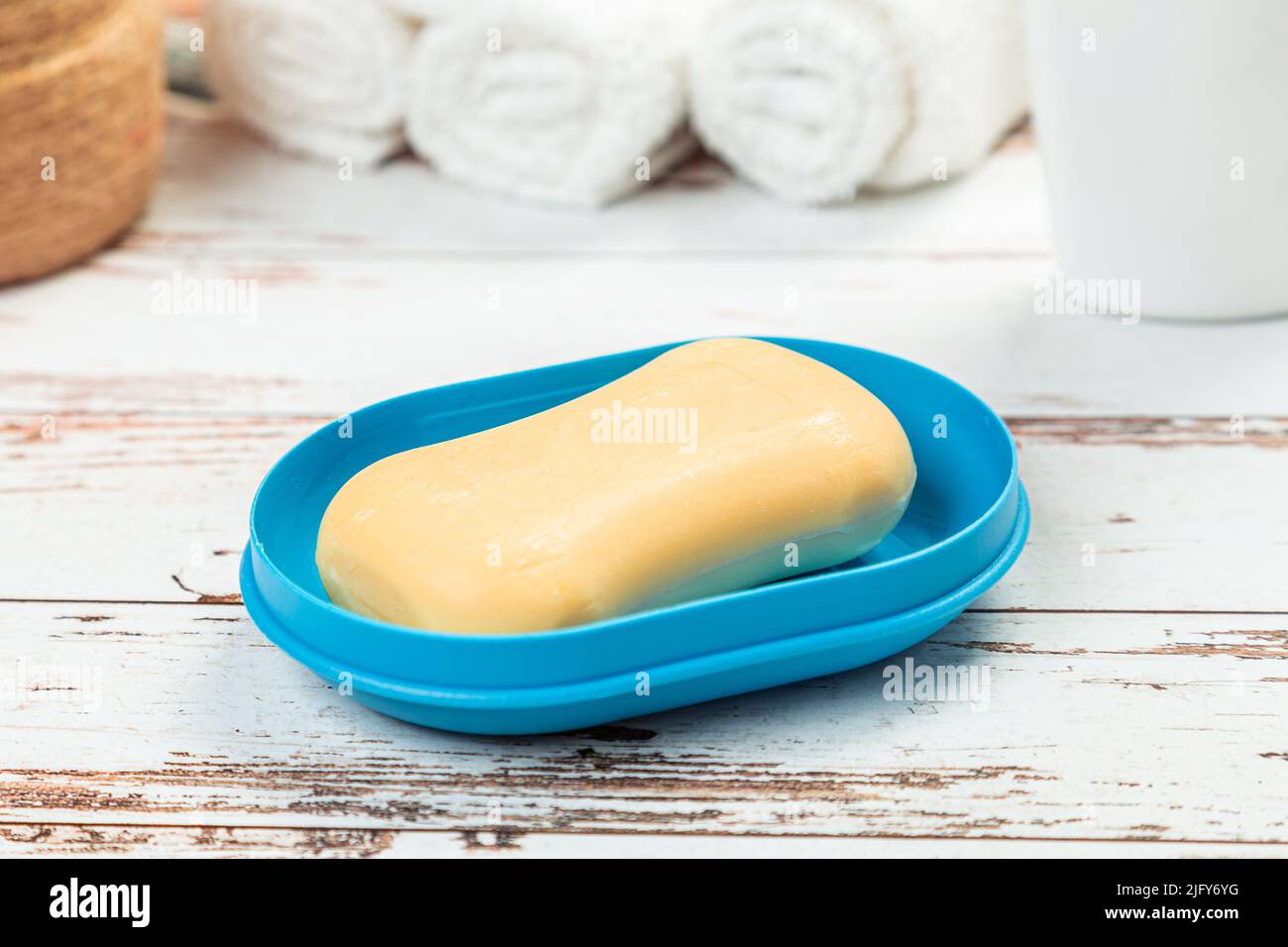 soap on a blue soap dish isolated on a wooden table. hygiene ...