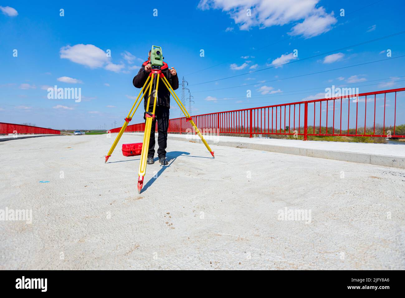 Surveyor engineer is measuring bridge under construction, site ...