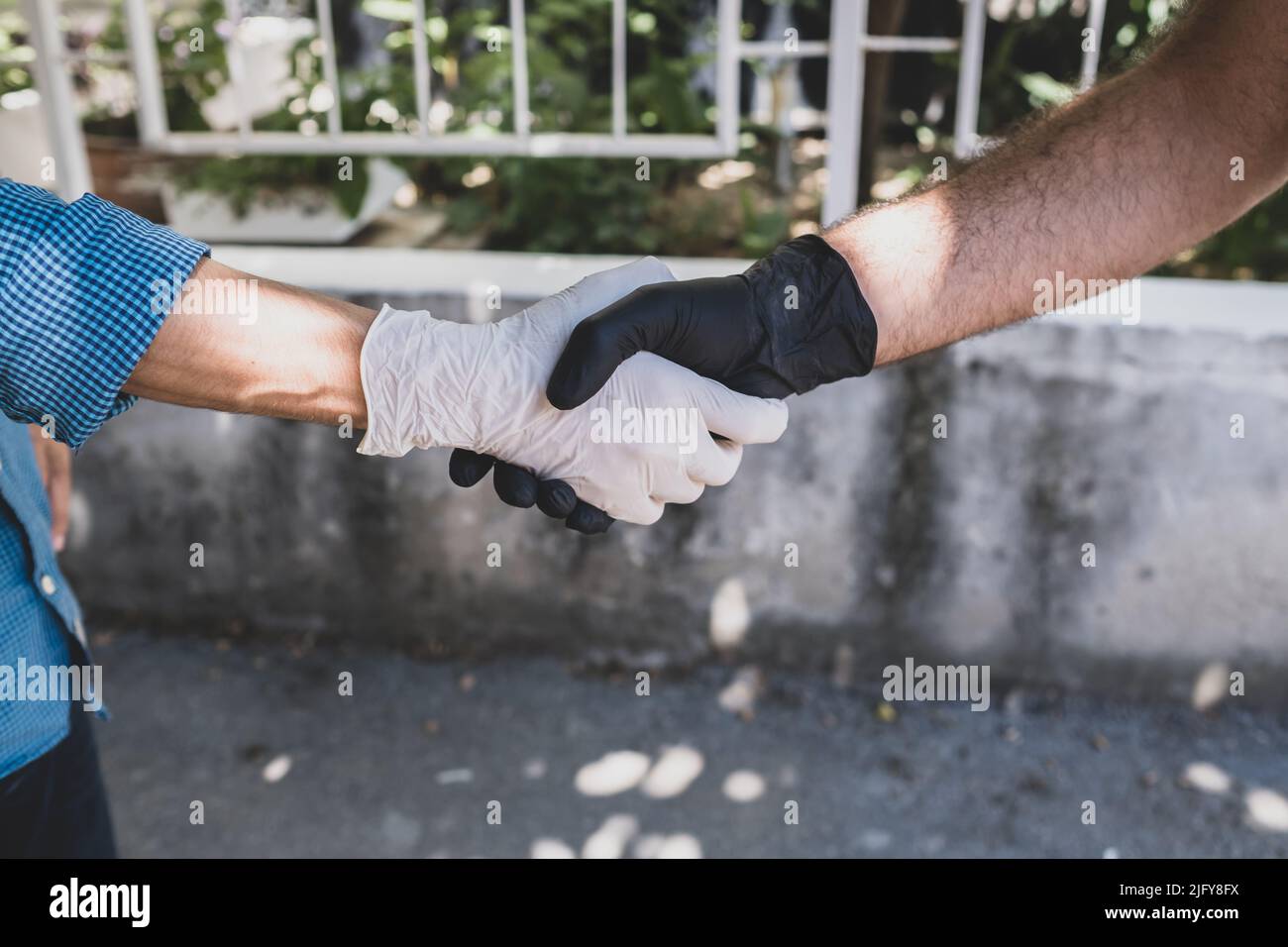 gloved handshake. Wearing gloves to avoid monkeypox and diseases ...