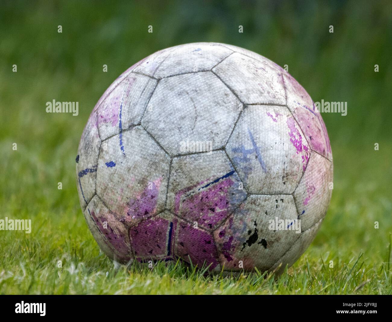 Dirty soccer ball on grass hi-res stock photography and images - Alamy