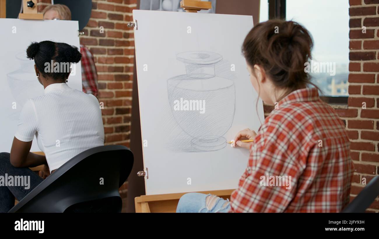 Artist creating vase drawing on canvas and easel, attending art class to develop artistic skills ...