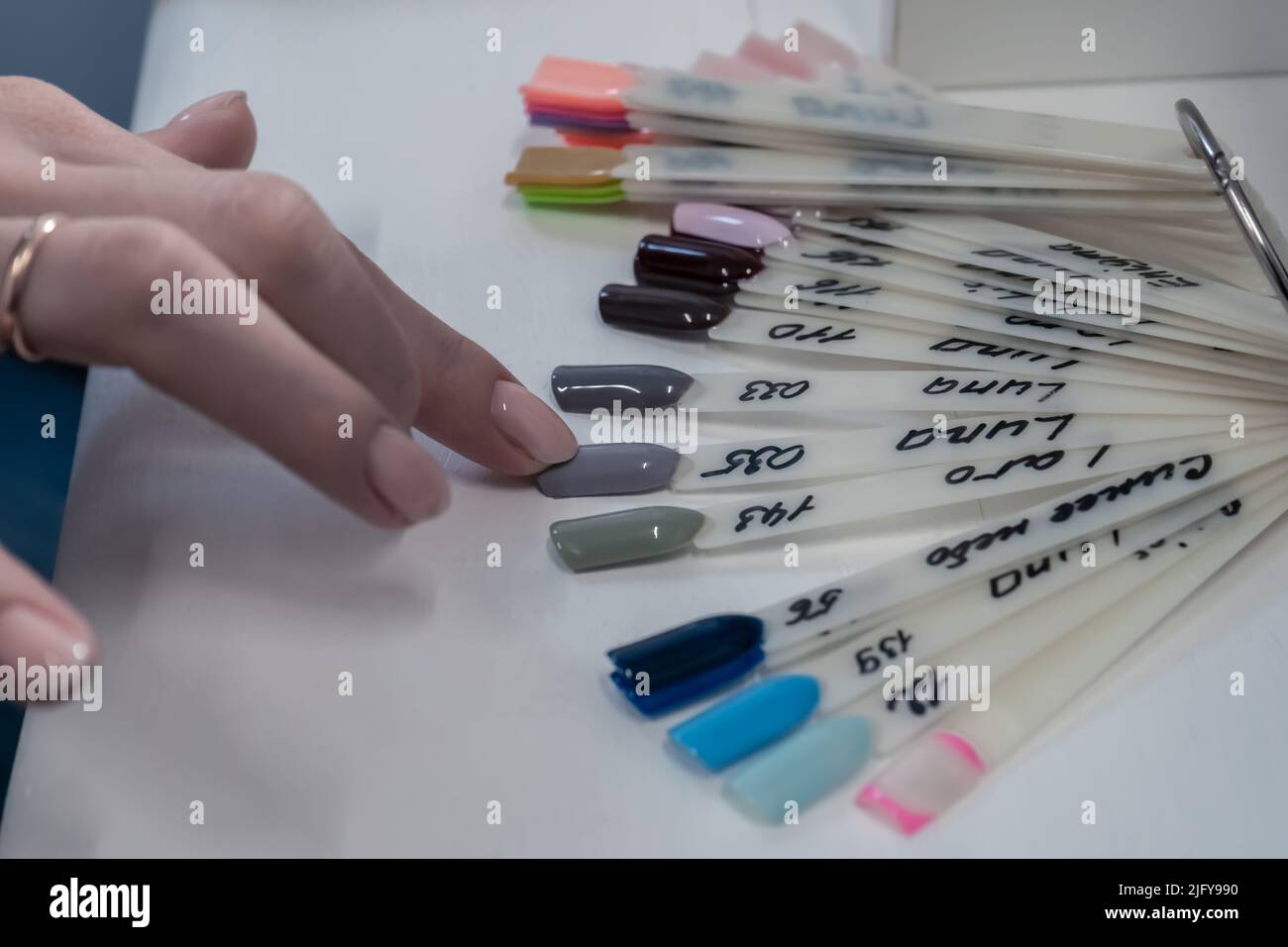 Manicure process, nail color selection Stock Photo - Alamy