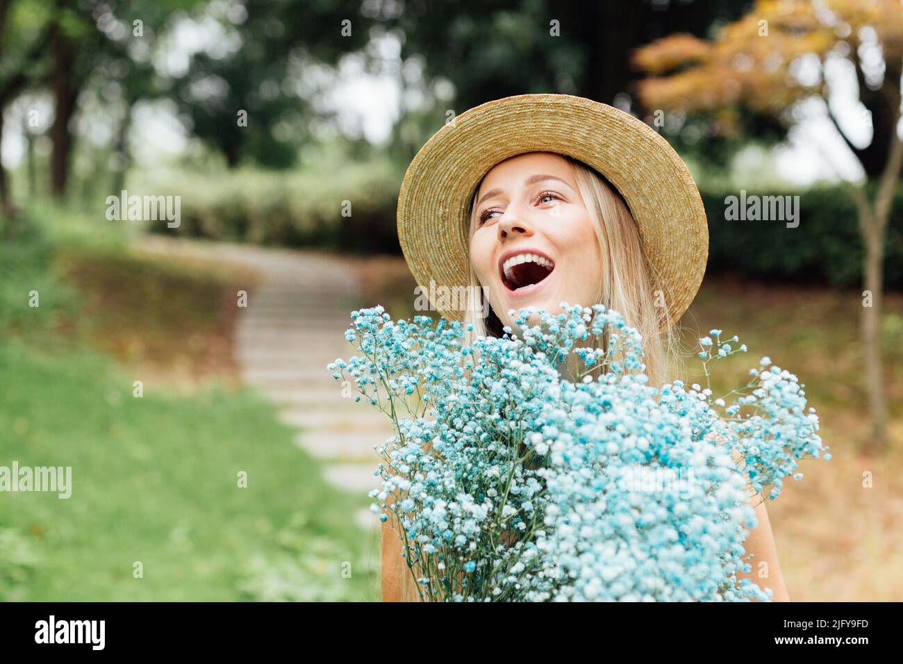 Portrait of beautiful stylish blonde millennial woman posing outdoor ...