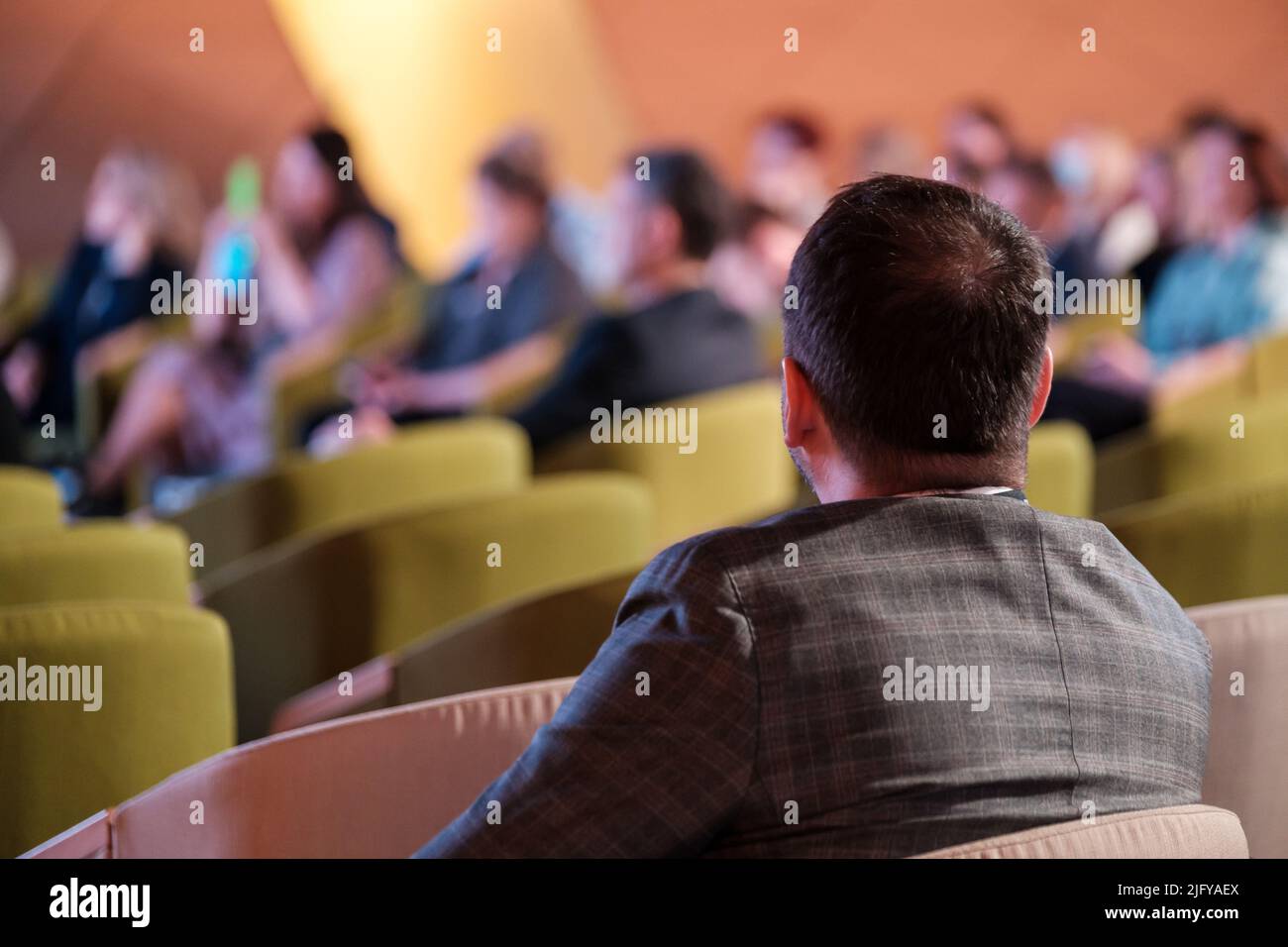 Anonymous male manager sitting in armchair at forum Stock Photo - Alamy