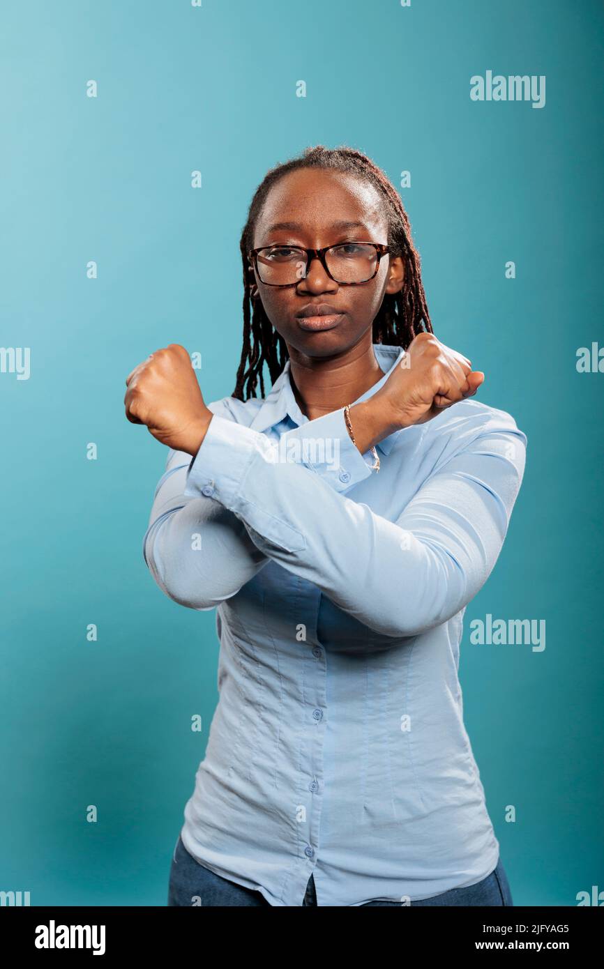 Confident and expressive woman making decline crossed arms symbol while ...