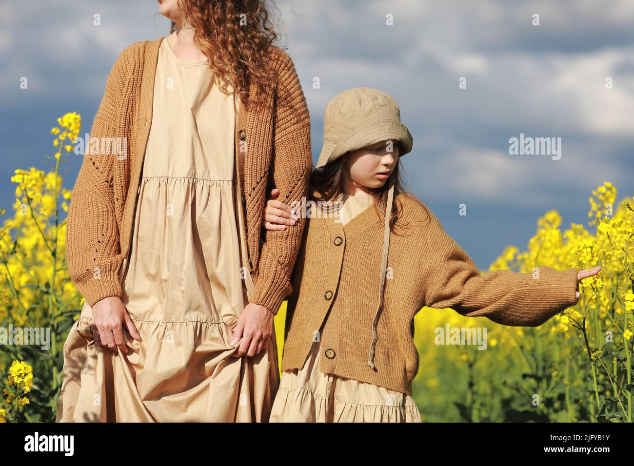 mothers day. young beautiful mom and child daughter is walking in the ...