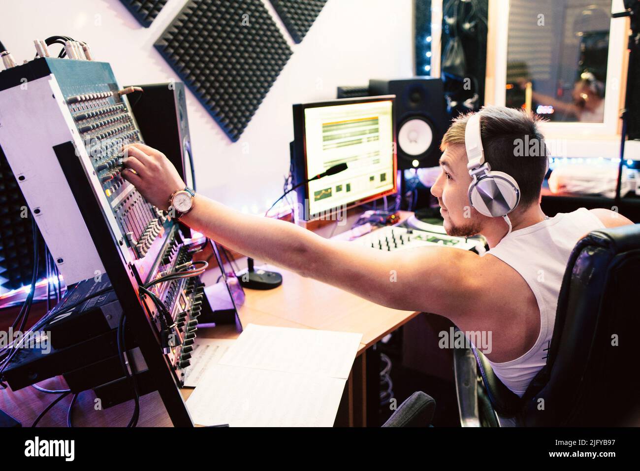 DJ adjusts equipment in sound recording studio Stock Photo - Alamy