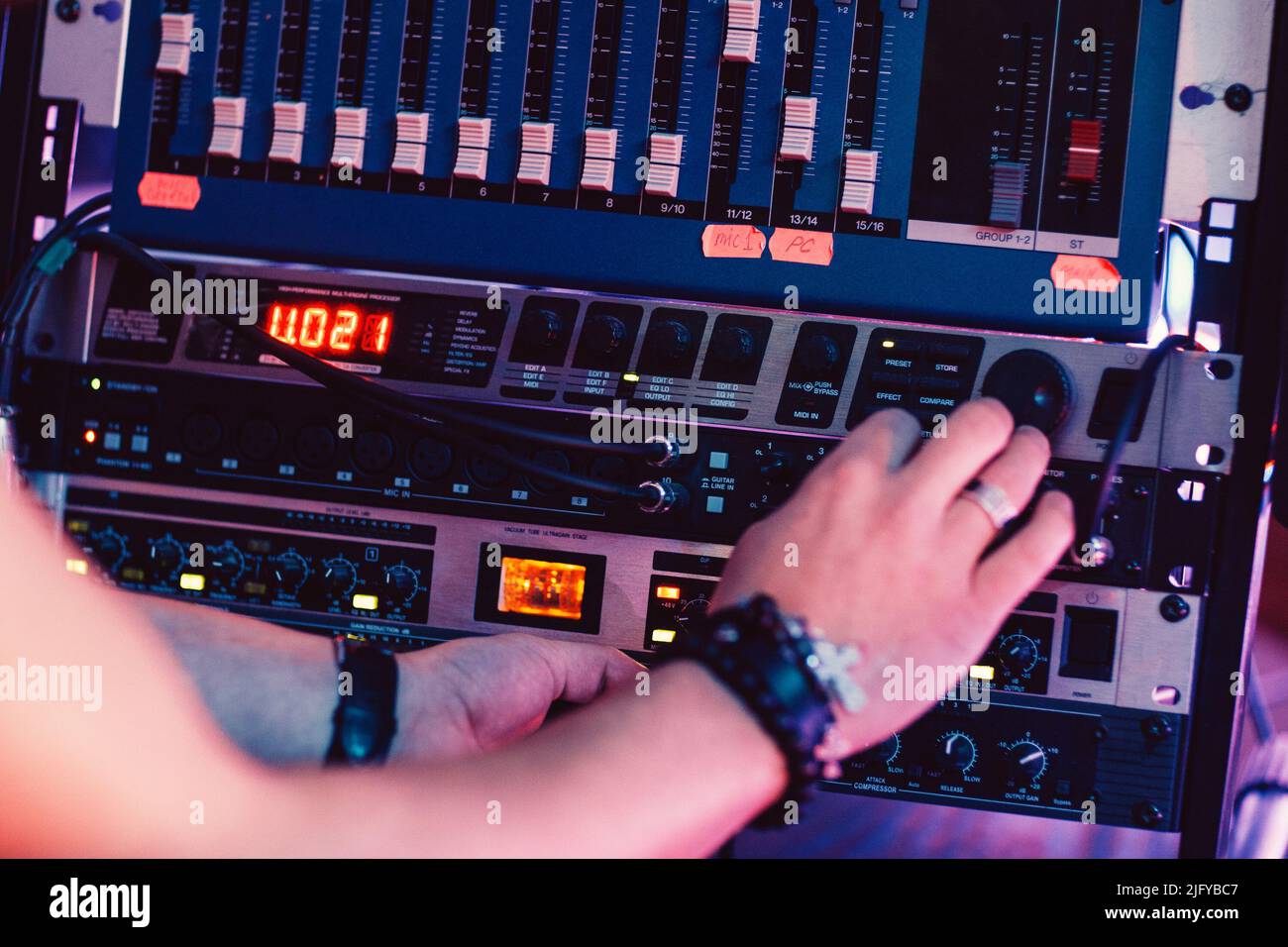 Musician adjusts sound panel in recording studio Stock Photo - Alamy