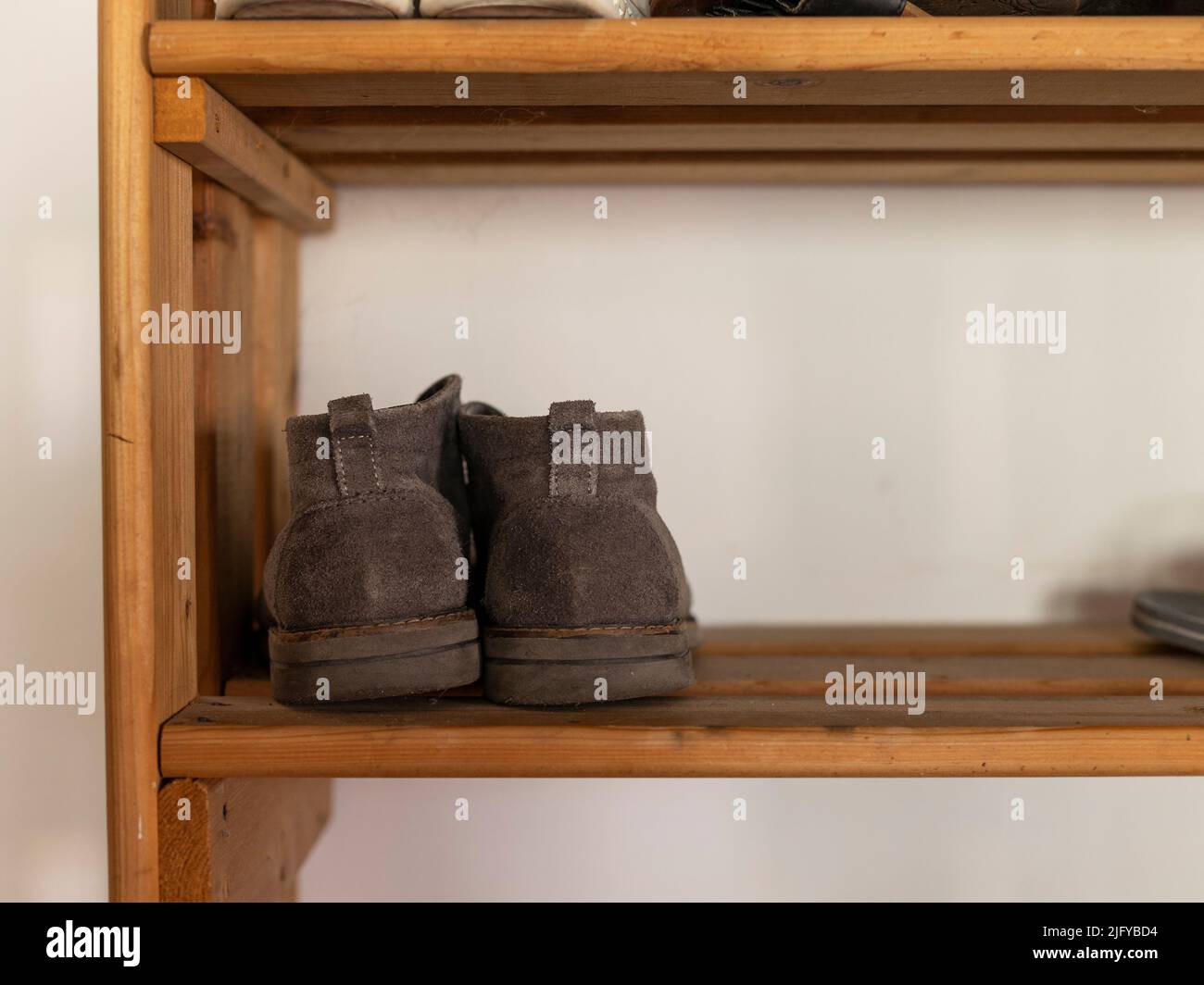 Old shoes on shelf detail at home Stock Photo - Alamy
