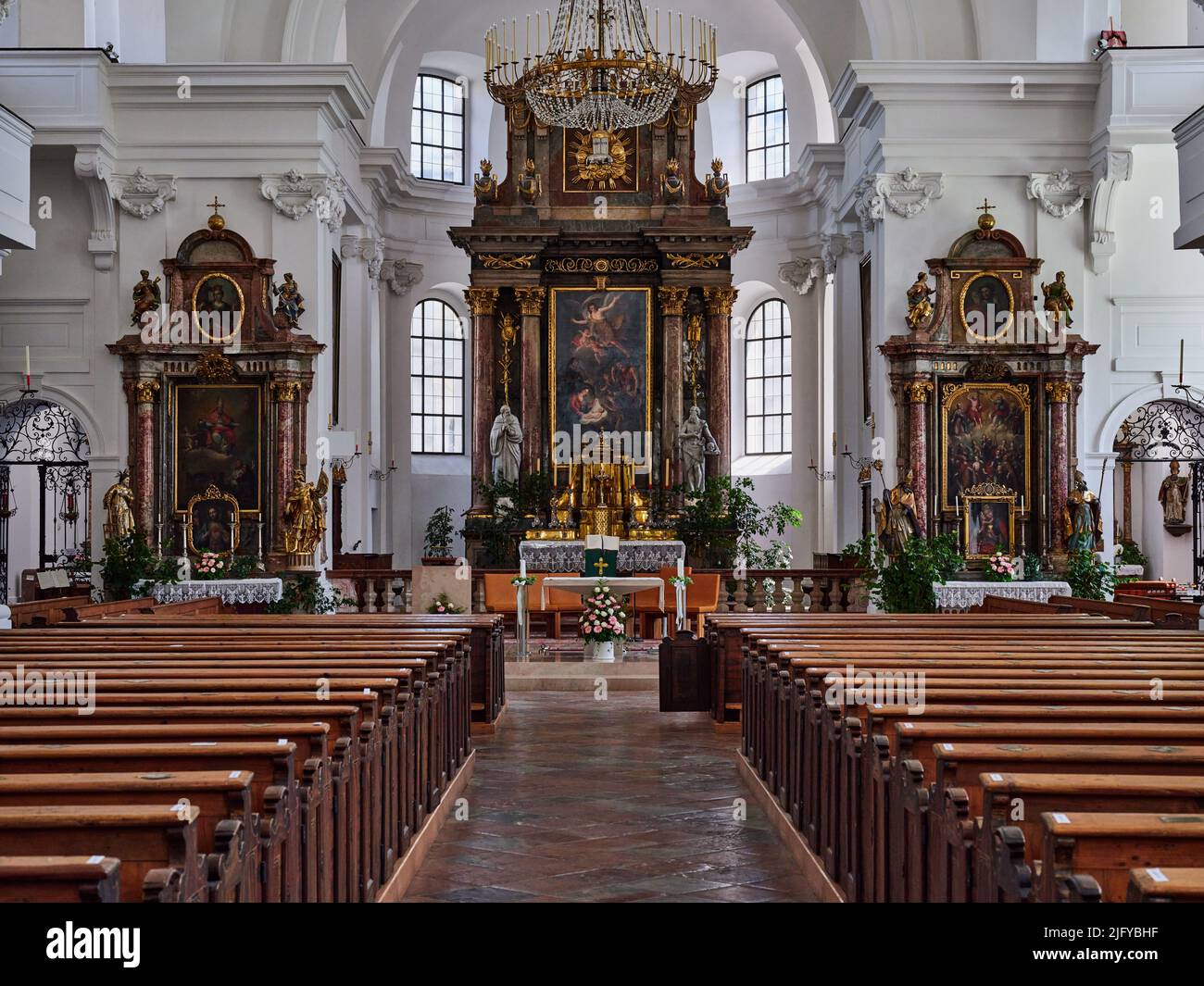 View between the wooden benches on altar and the chandelier inside the ...