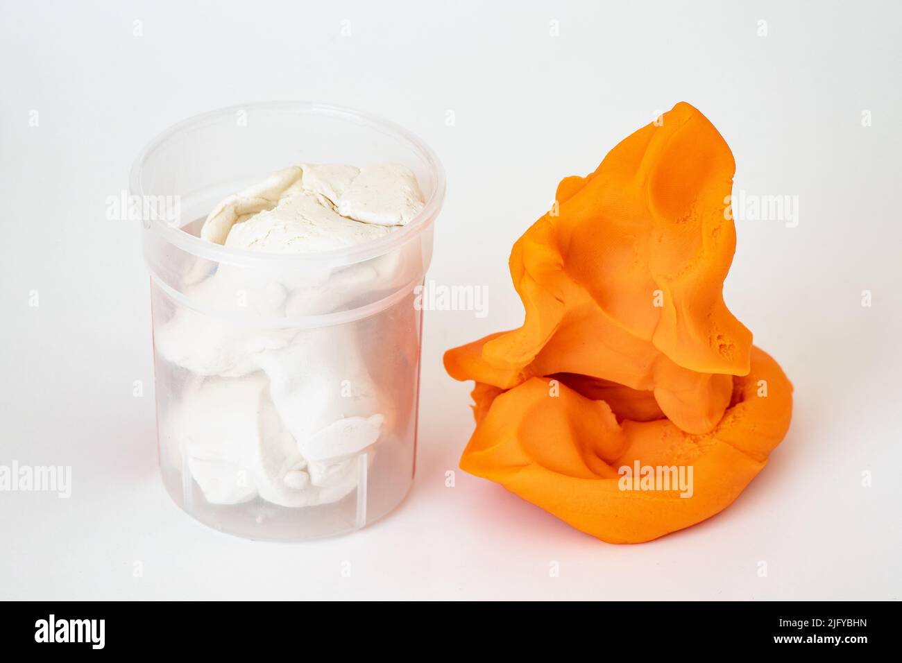 Orange colorful play dough for kids on white background. Children ...