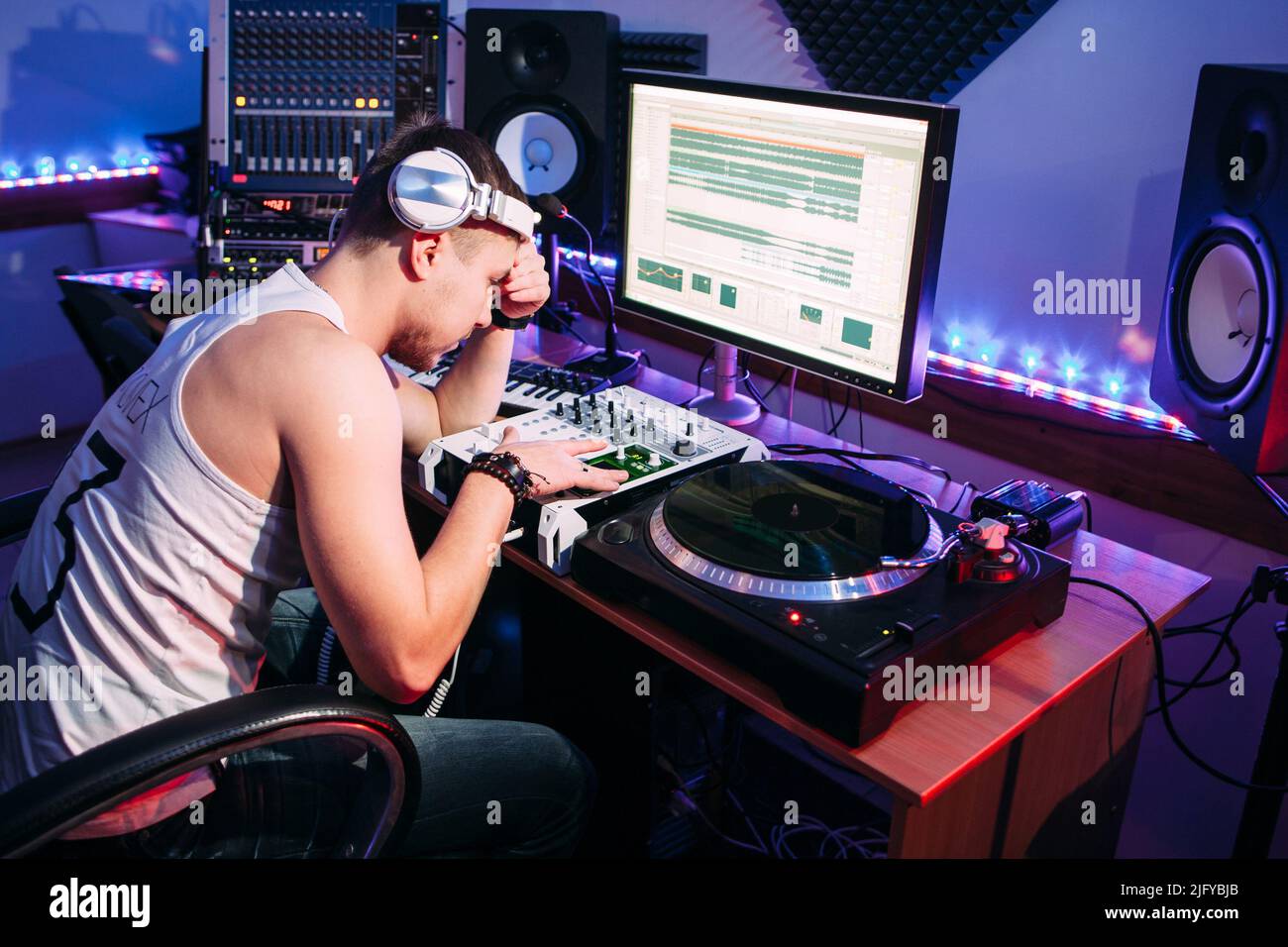 DJ studies sound programm in recording studio Stock Photo - Alamy