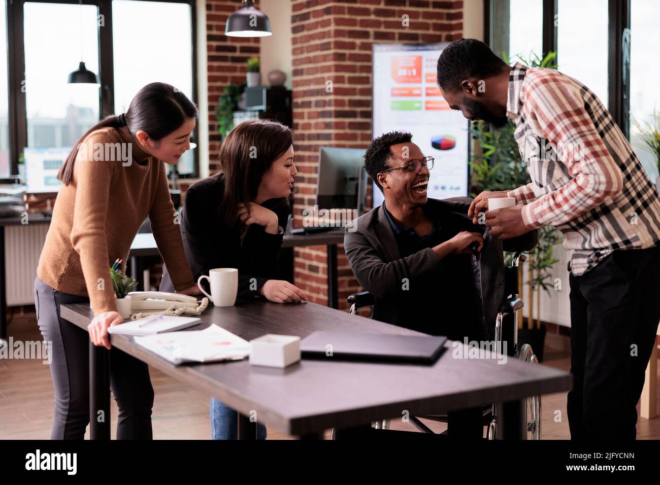 African american man with physical impairment having fun at work ...
