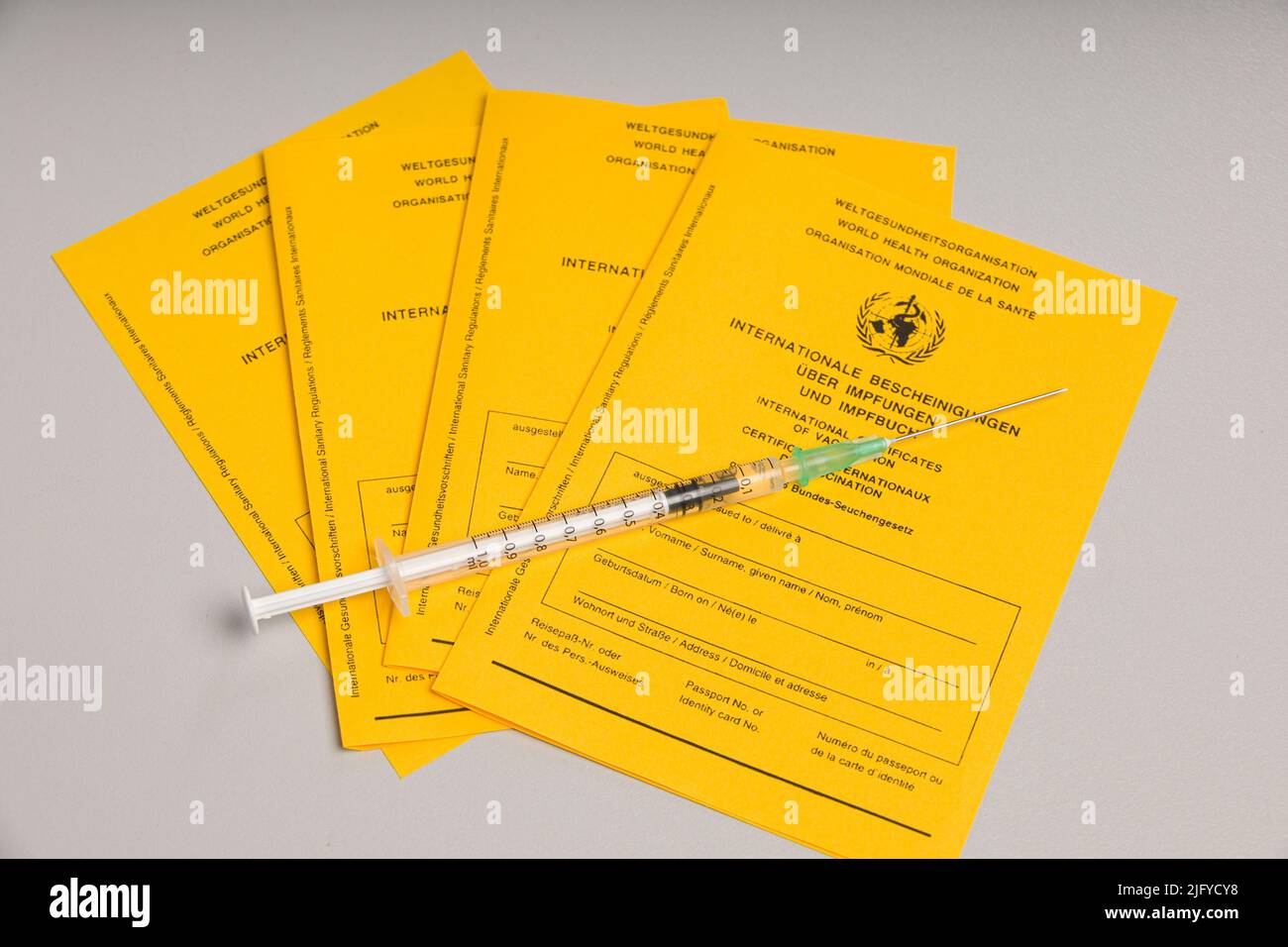 international certificates of vaccination and a syringe with covid-19 ...