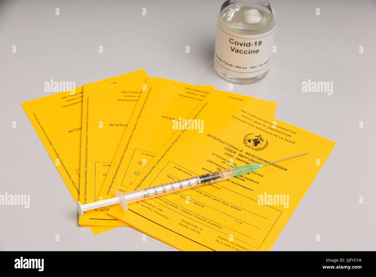 international certificates of vaccination and a syringe with covid-19 ...