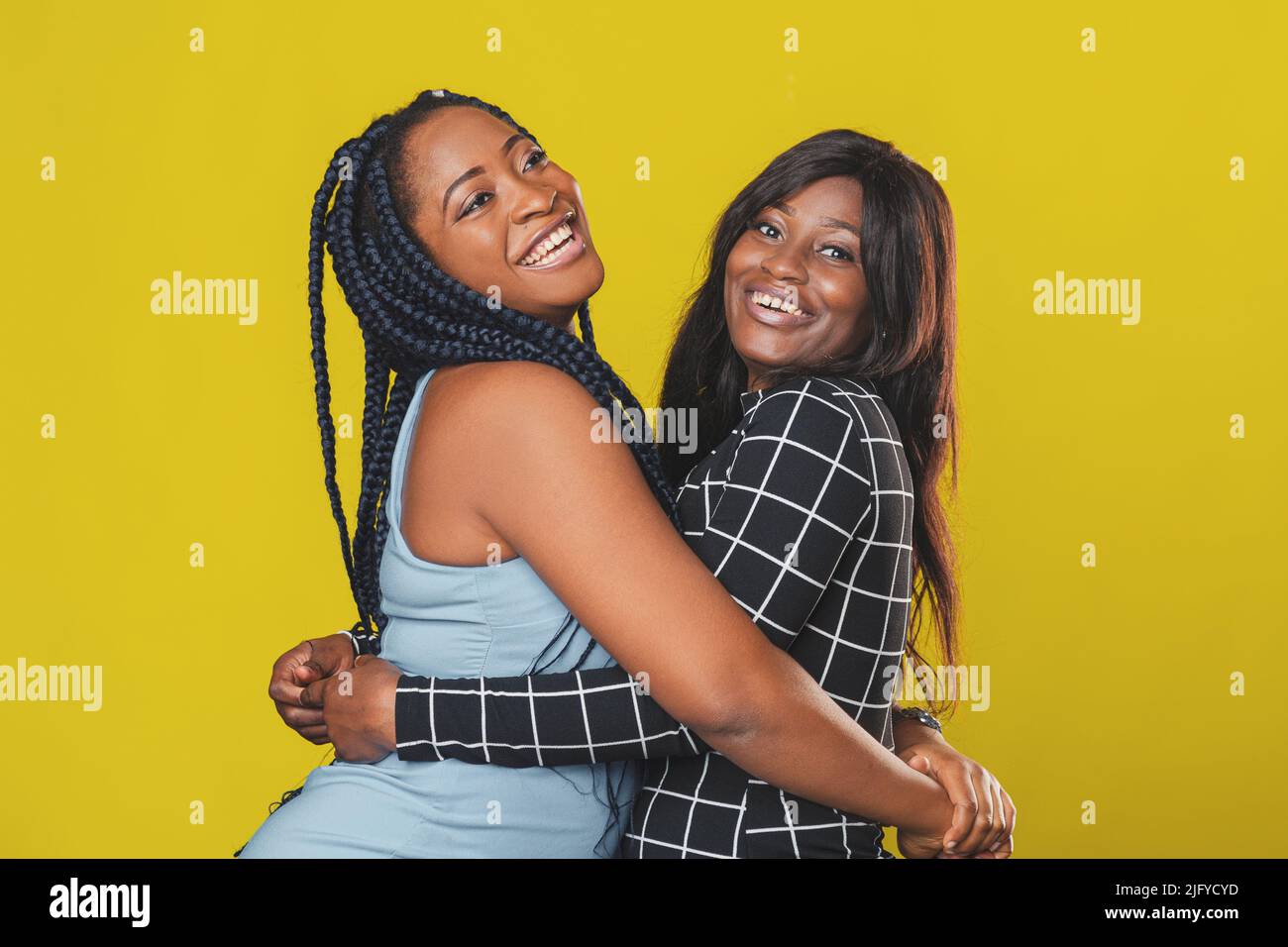 two beautiful afro american girls hugging and rejoicing and smiling on ...