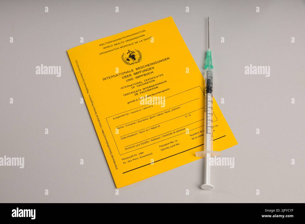 international certificates of vaccination and a syringe with covid-19 ...