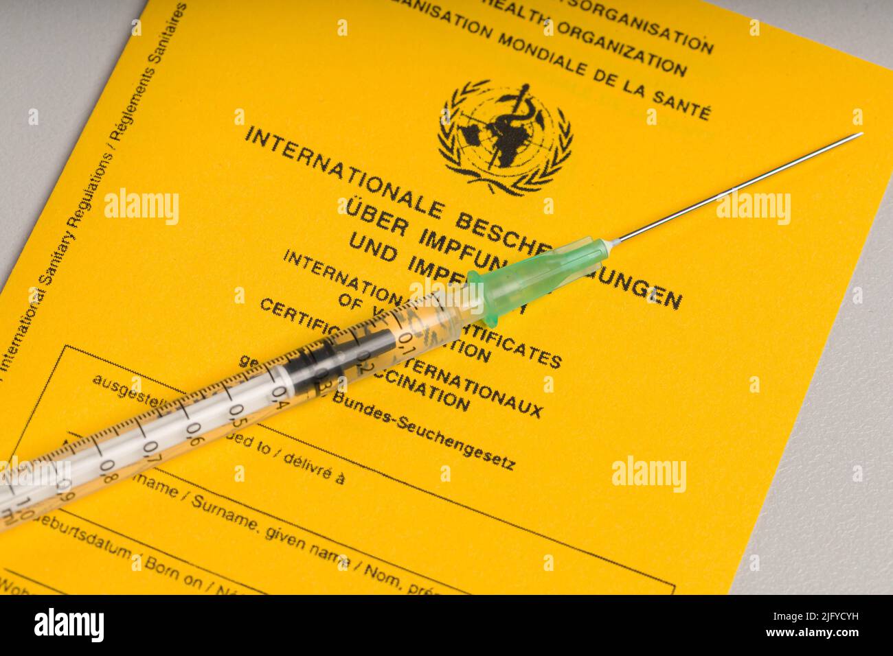 international certificates of vaccination and a syringe with covid-19 ...