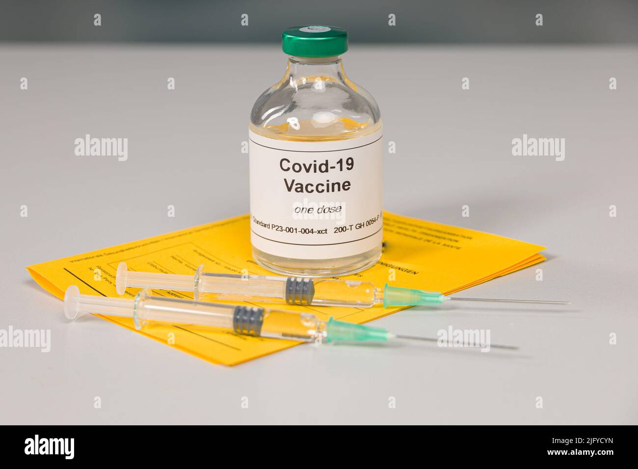 international certificates of vaccination and a syringe with covid-19 ...