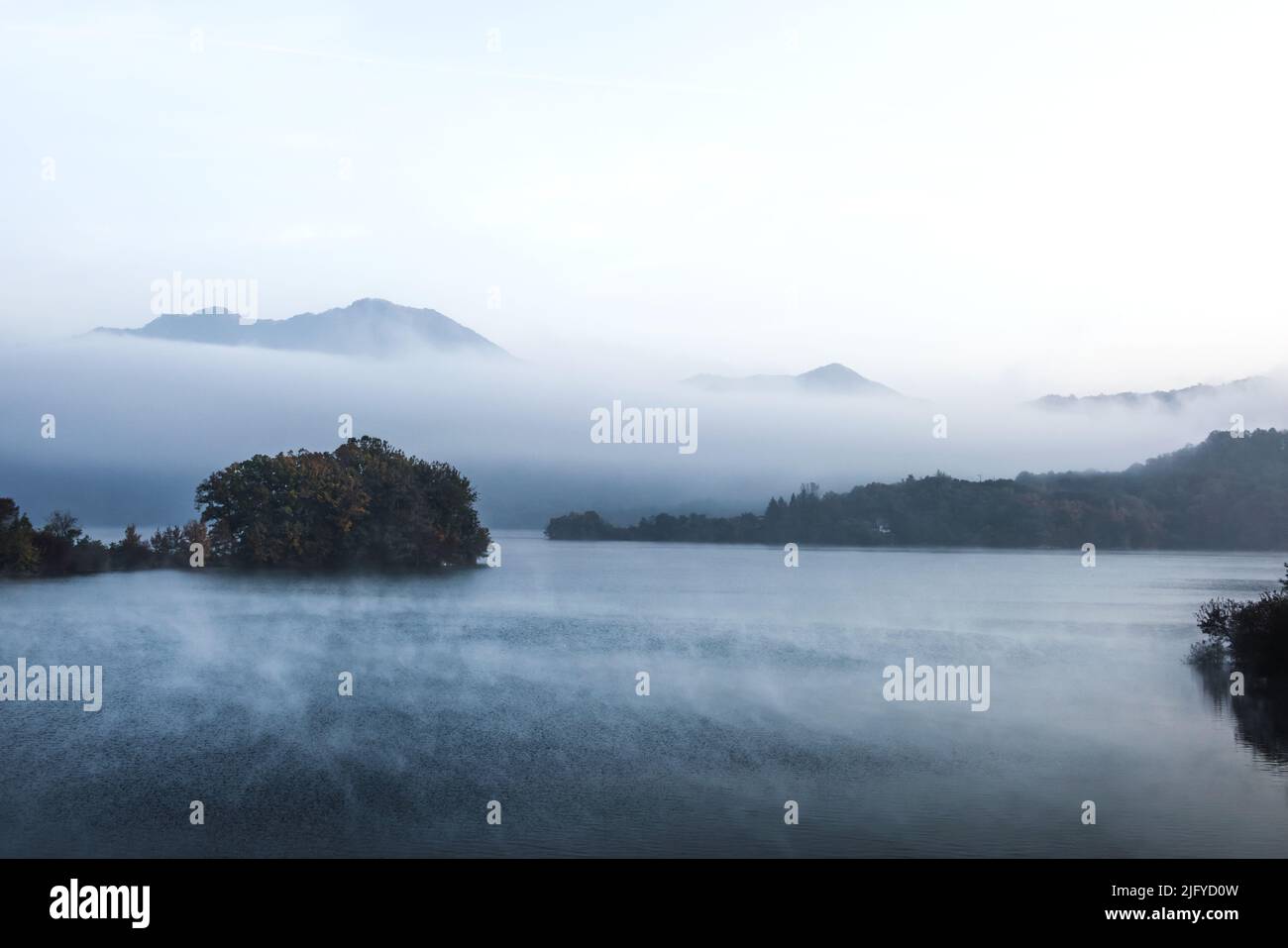 Beautiful autumn scenery, water mist over the lake and sea clouds on ...