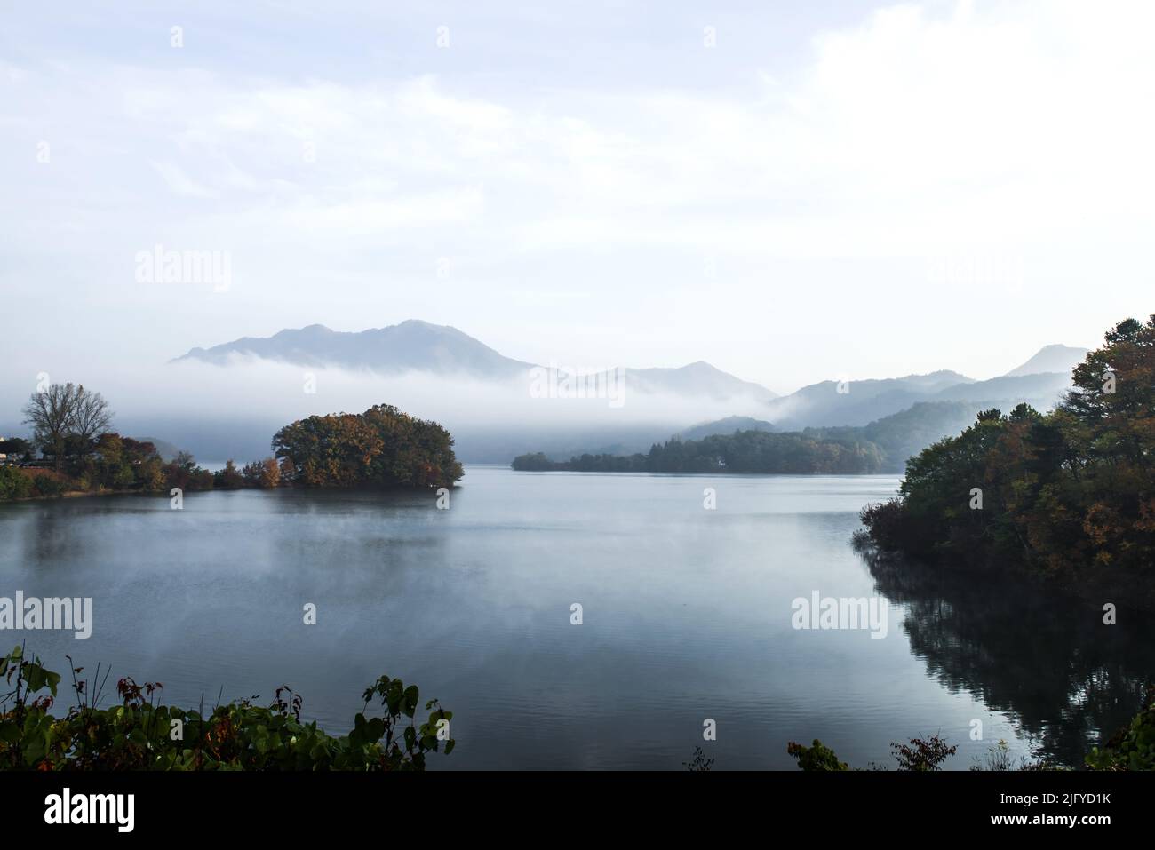 Beautiful autumn scenery, water mist over the lake and sea clouds on ...