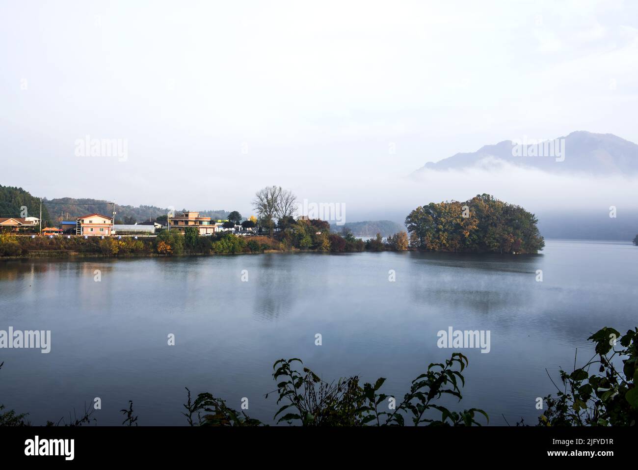 Beautiful autumn scenery, water mist over the lake and sea clouds on ...