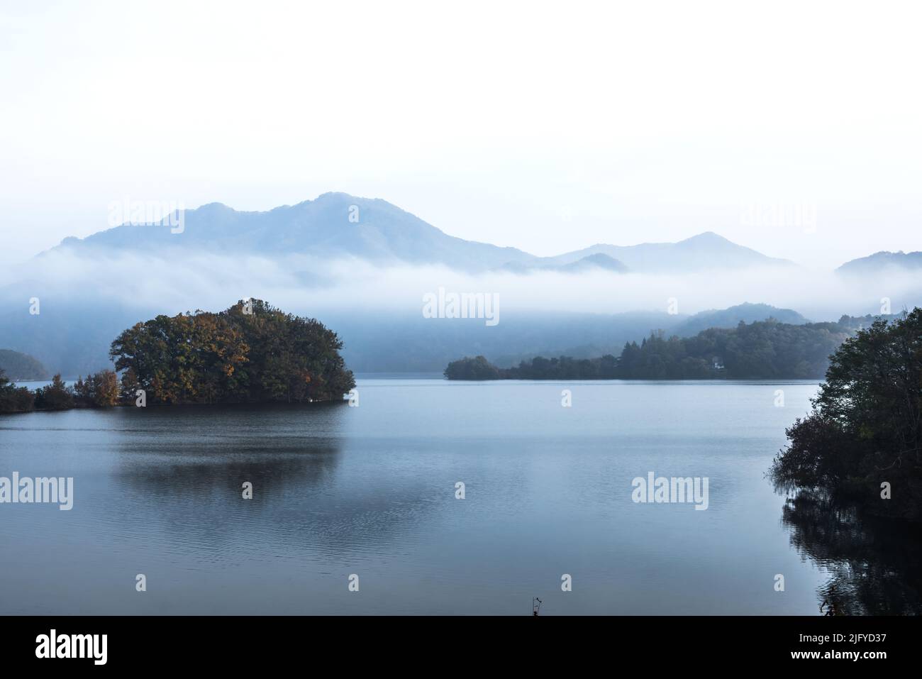 Beautiful autumn scenery, water mist over the lake and sea clouds on ...