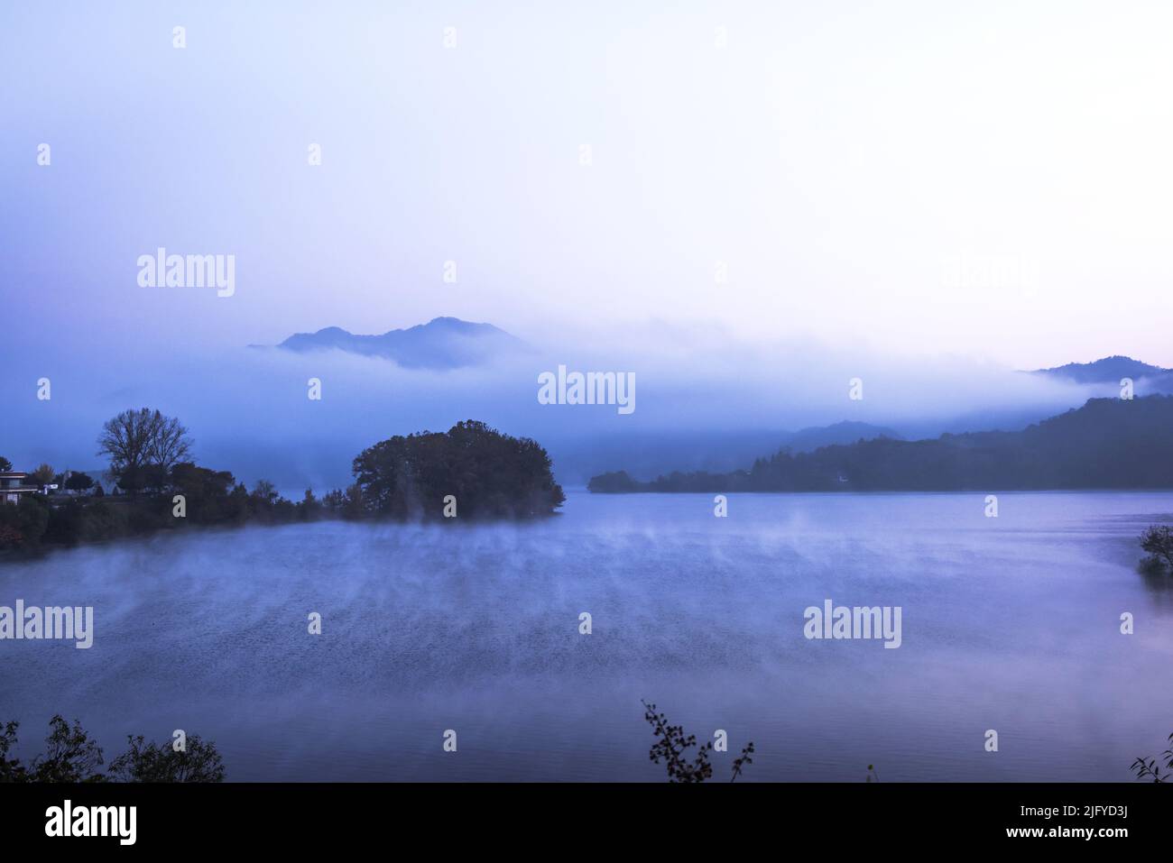Beautiful autumn scenery, water mist over the lake and sea clouds on ...