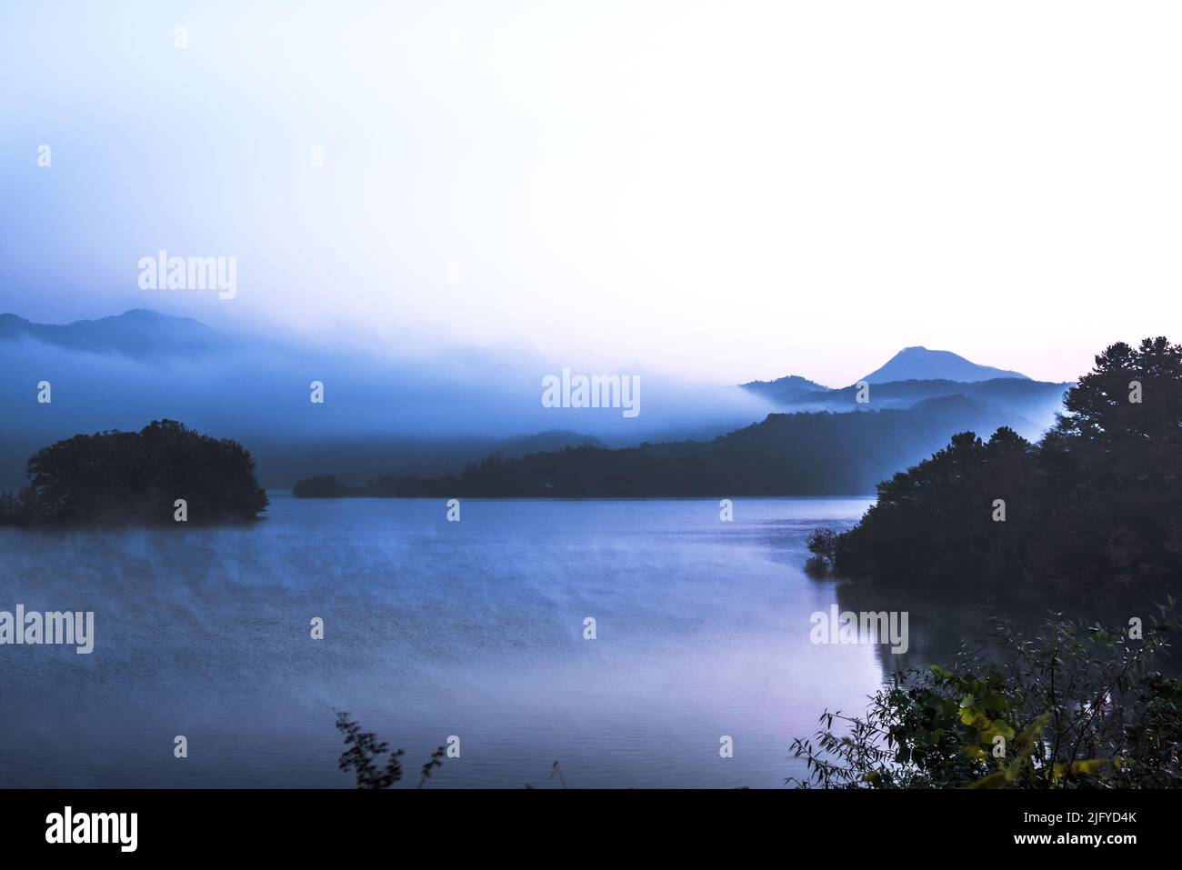 Beautiful autumn scenery, water mist over the lake and sea clouds on ...