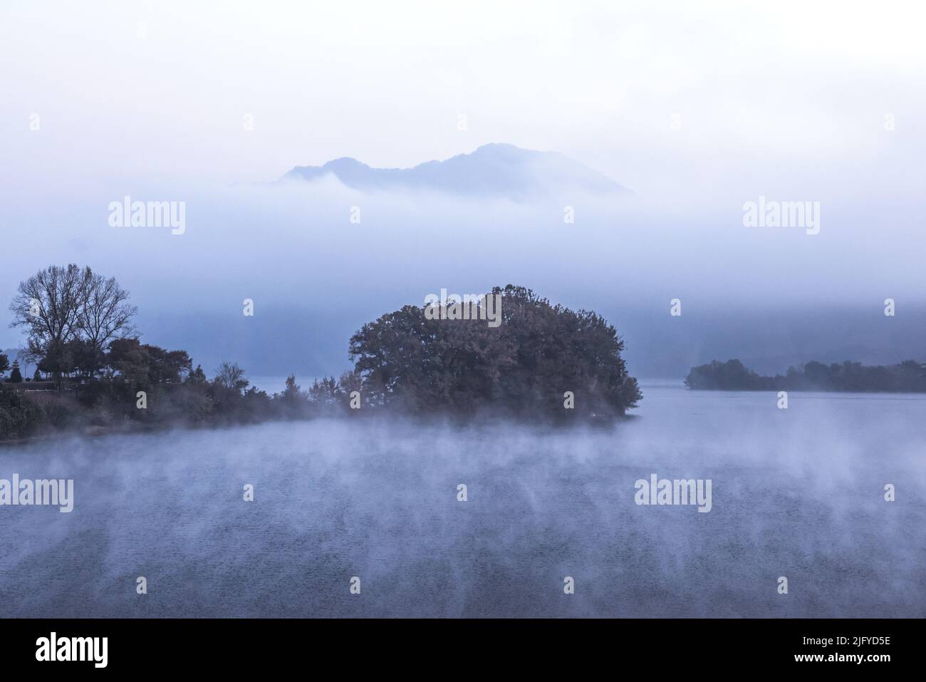 Beautiful autumn scenery, water mist over the lake and sea clouds on ...