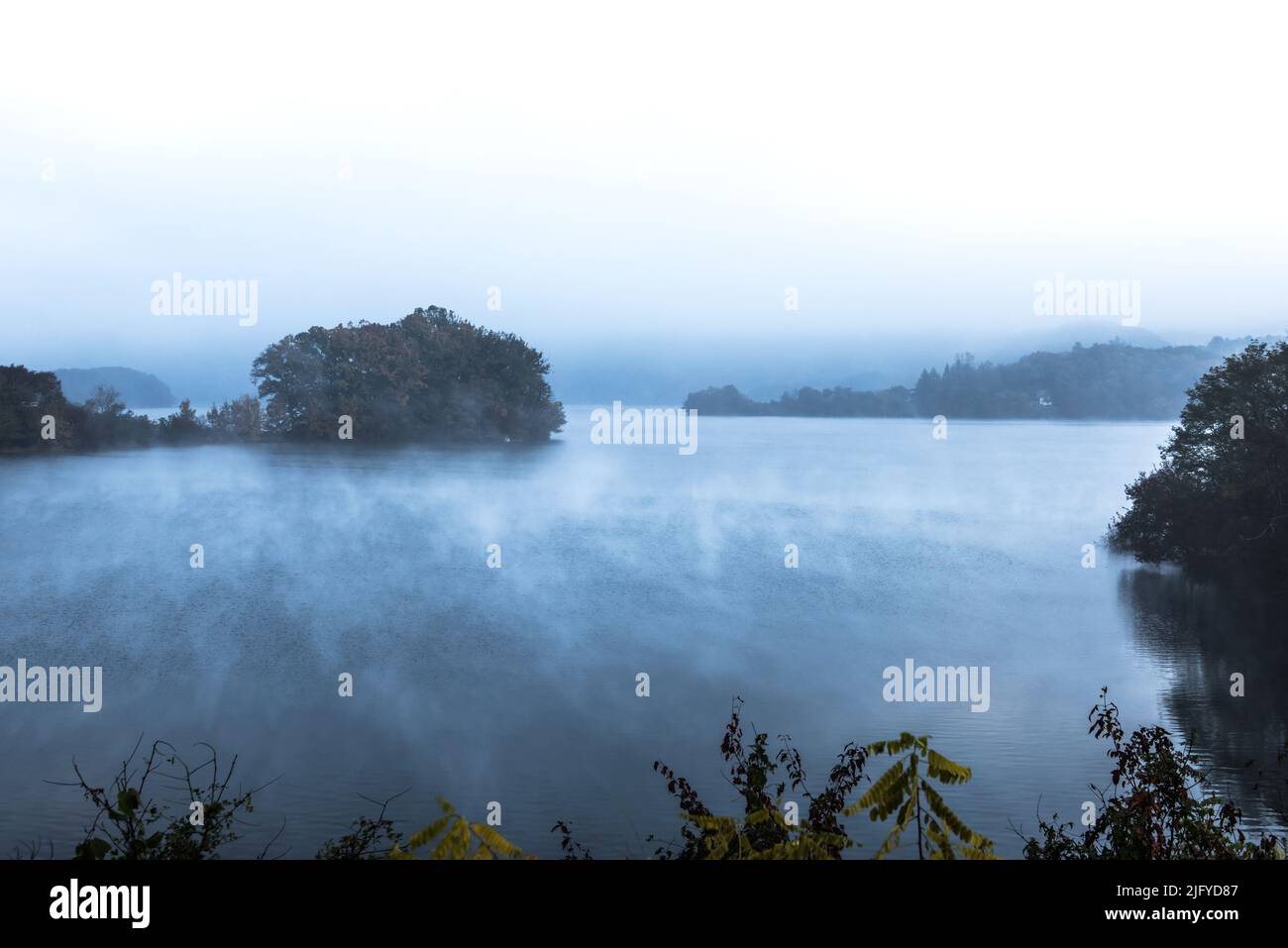 Beautiful autumn scenery, water mist over the lake and sea clouds on ...