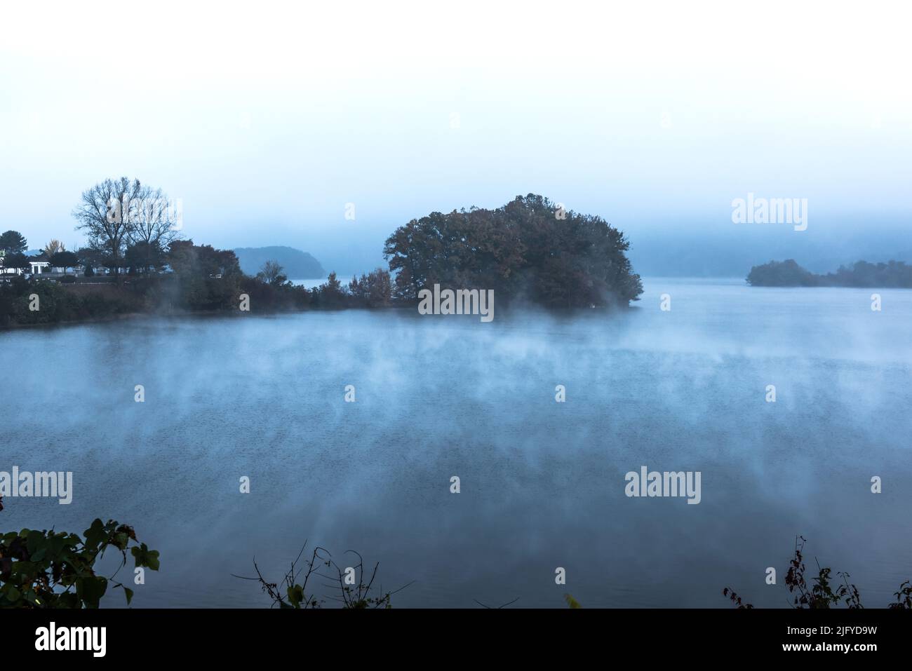 Beautiful autumn scenery, water mist over the lake and sea clouds on ...