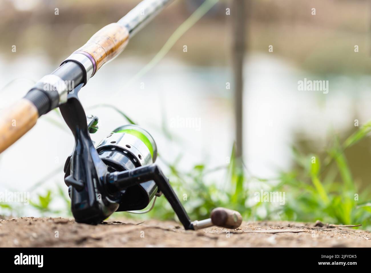 Close up fishing reel and rod in fisherman hand in a pond Stock Photo ...