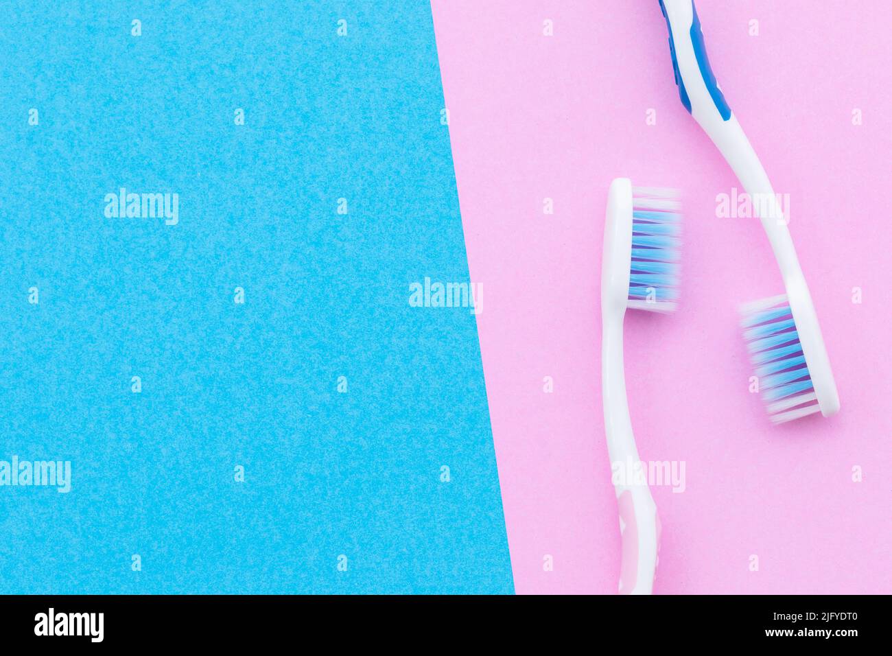 Top view new pink and blue toothbrush on pink background with copy ...