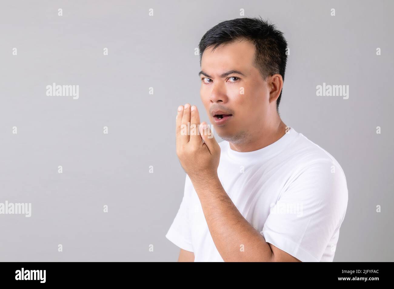 Health Care : Man checking his breath with hand. Portrait asian man are ...