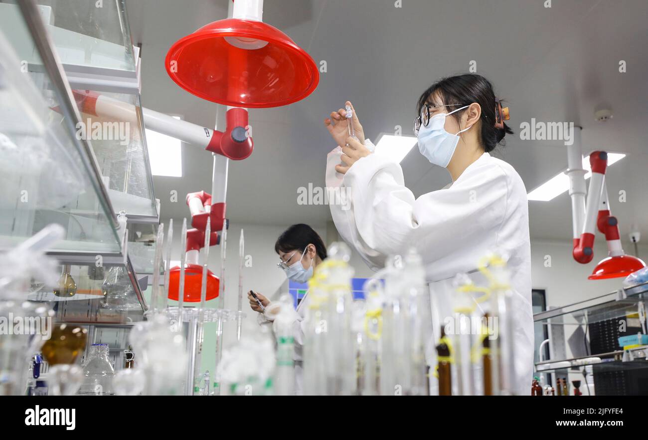 A researcher from a pharmaceutical company performs an experiment in a ...