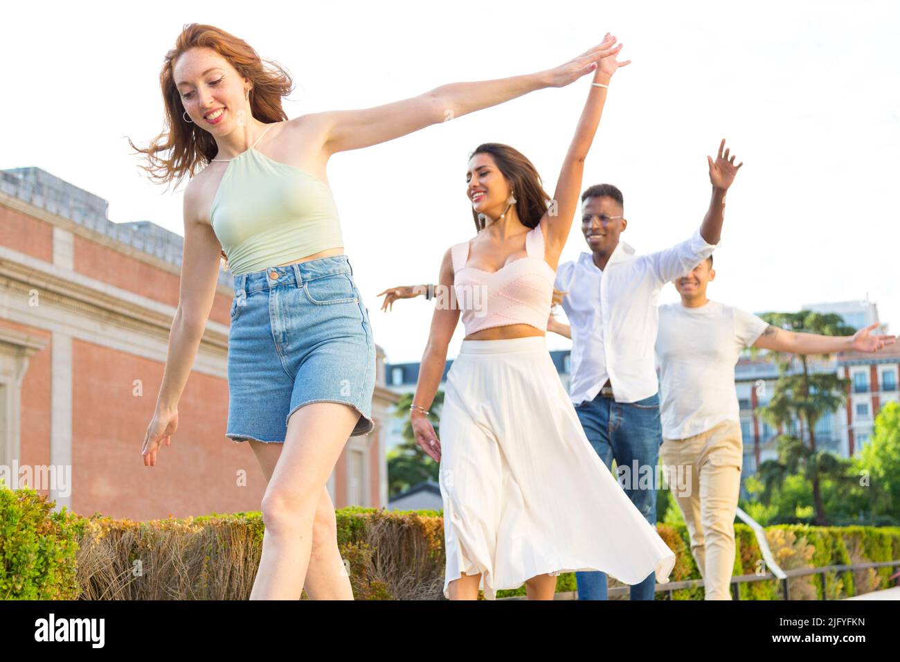 Multiethnic group of people walking in line in a playful manner Stock ...