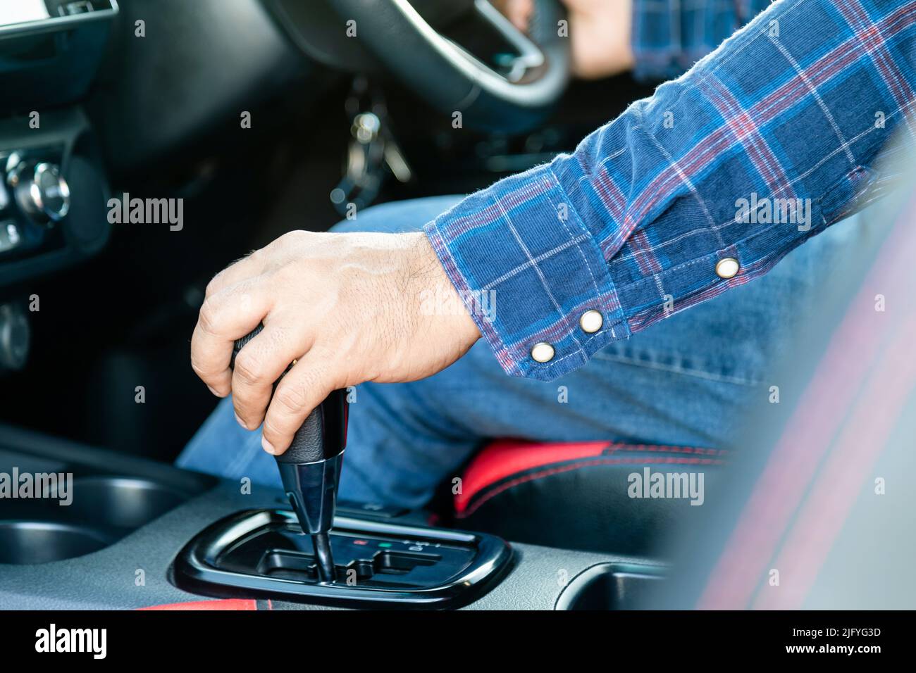 Car driving concept : Close up driver hand on automatic gear stick ...