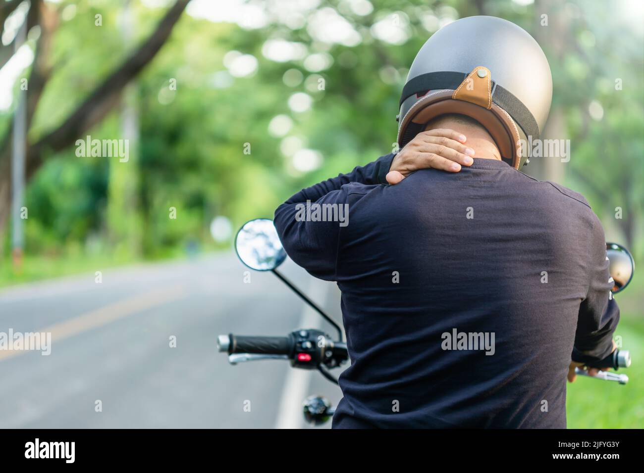 Motorcyclist with pain or tired concept : Man rider touching on his ...