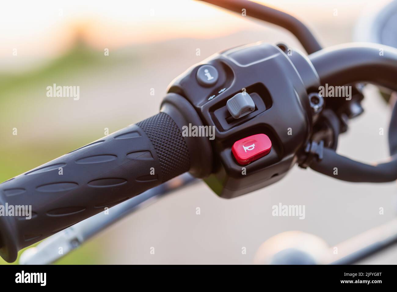 Red horn switch. Macro left handle bar with hand clutch of motorcycle ...