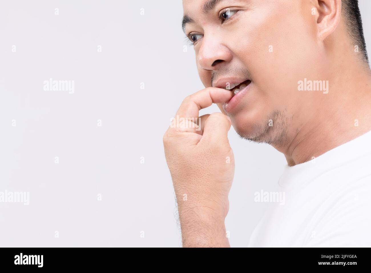 Nail Biting (Onychophagia) concept : Portrait people biting his nail ...