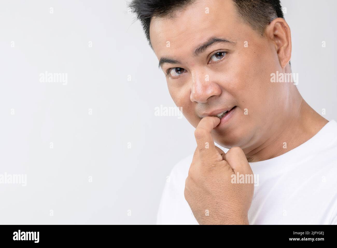 Nail Biting (Onychophagia) concept : Portrait people biting his nail ...