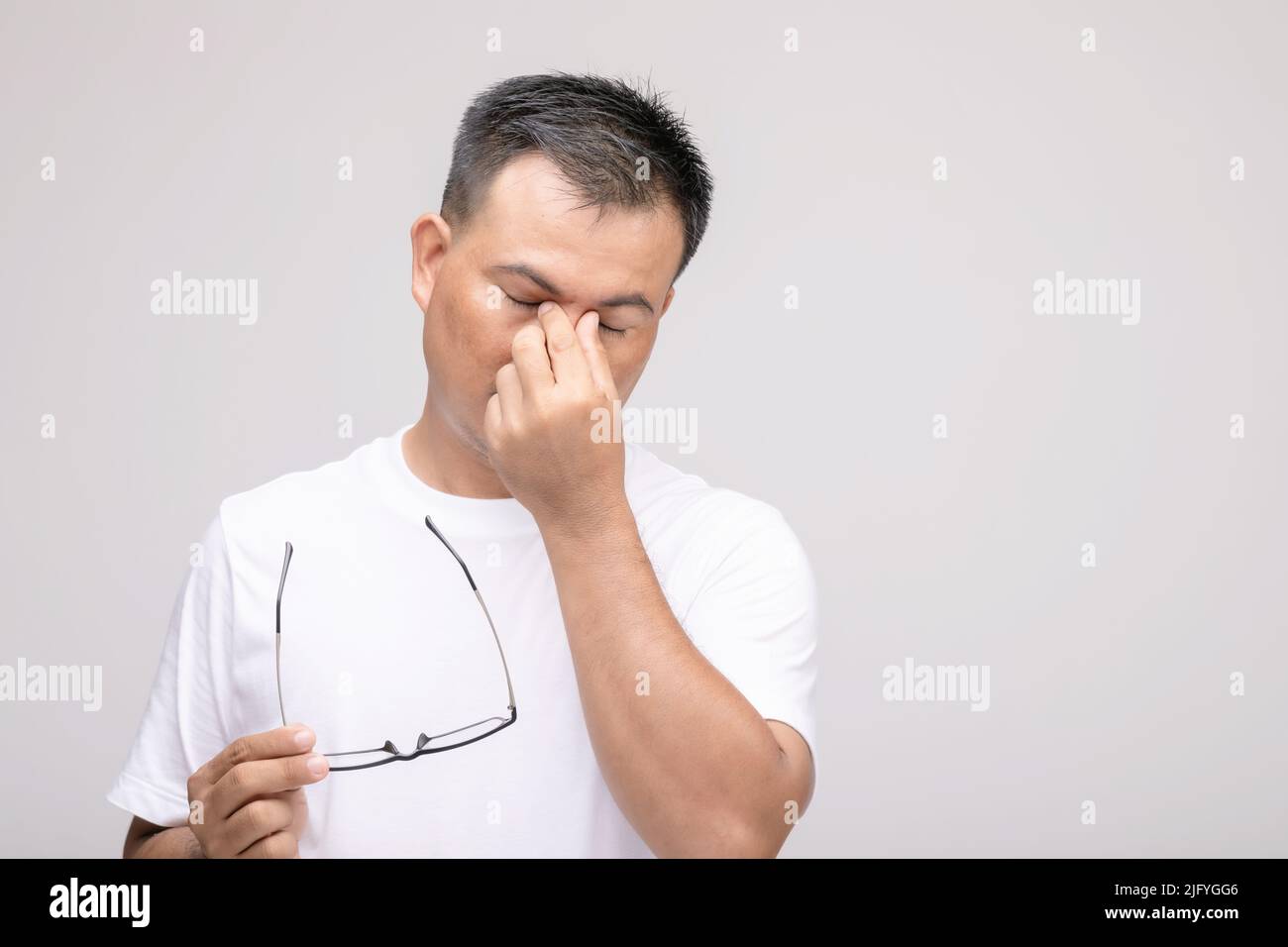 Eye irritation concept : Portrait of Asian man in posture of eye tired ...