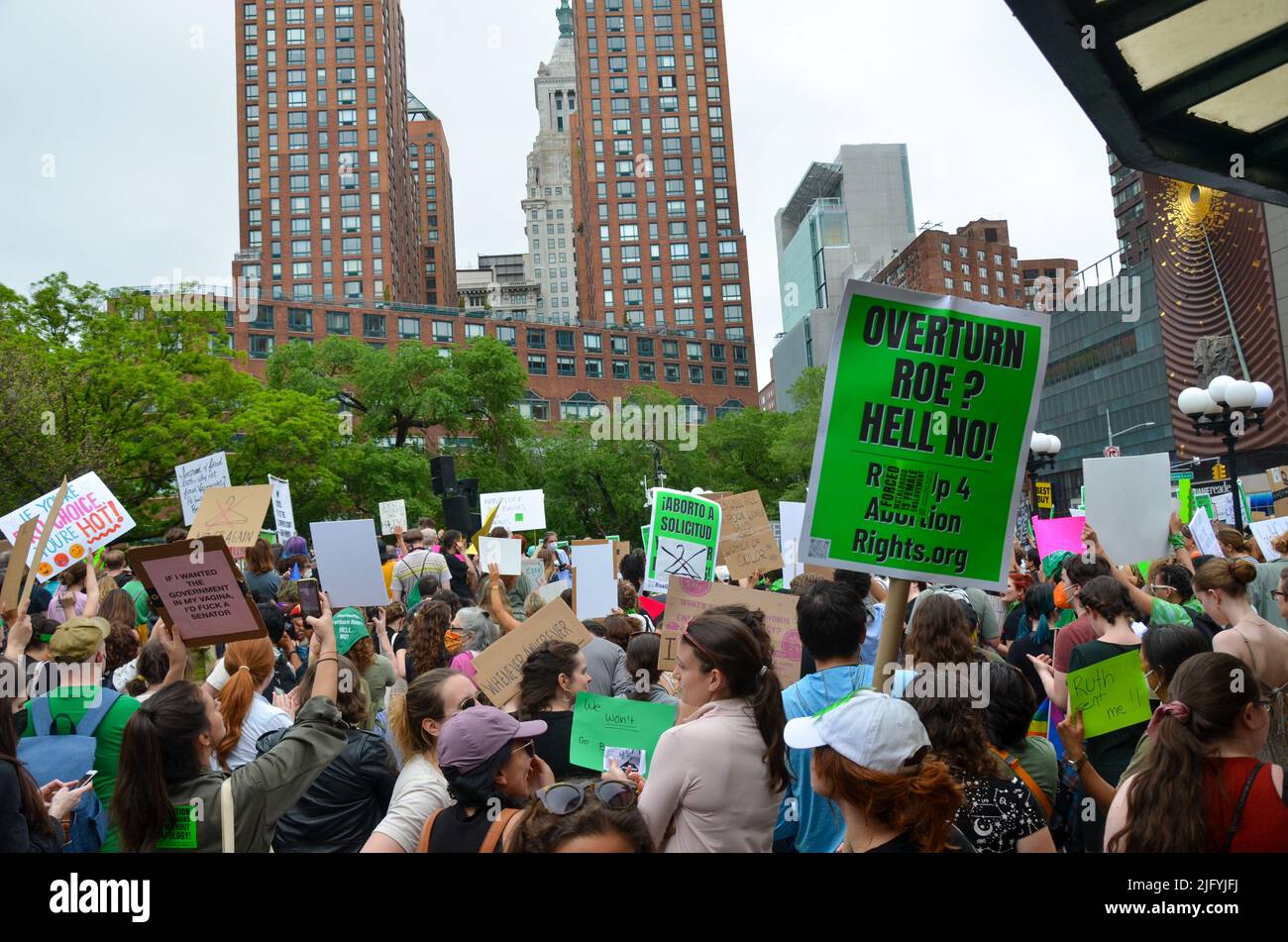 A crowd of protesters holding demonstration signs after Supreme Court ...