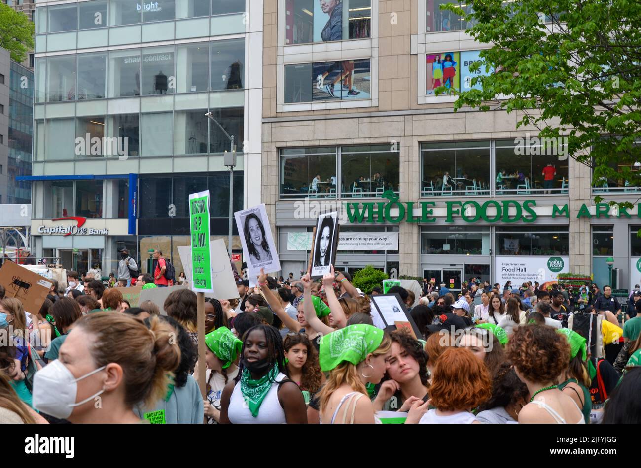 A crowd of protesters holding cardboard signs after Supreme Court ...