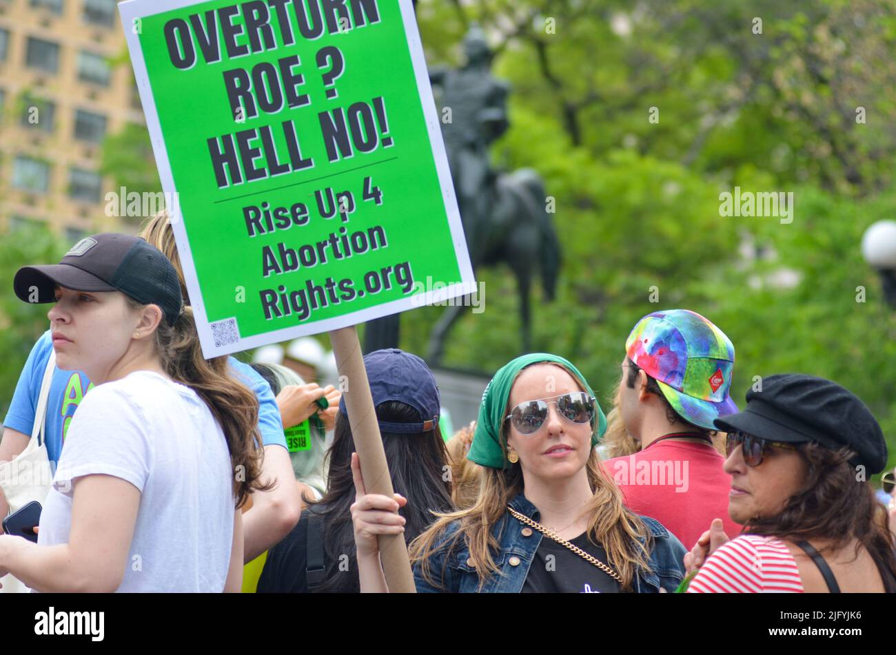 A crowd of protesters holding cardboard signs after Supreme Court ...