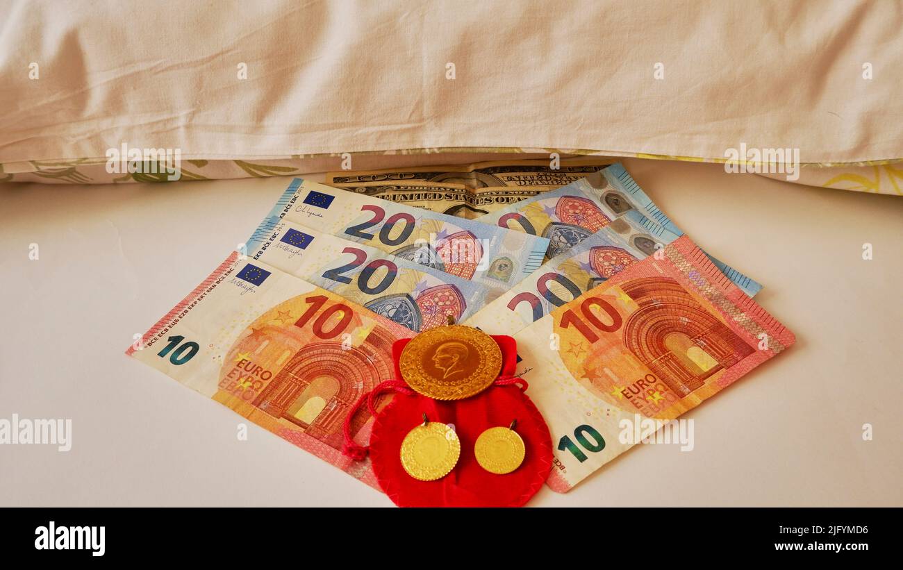 Money or euro, dollar and gold coins under the pillow or on the white ...