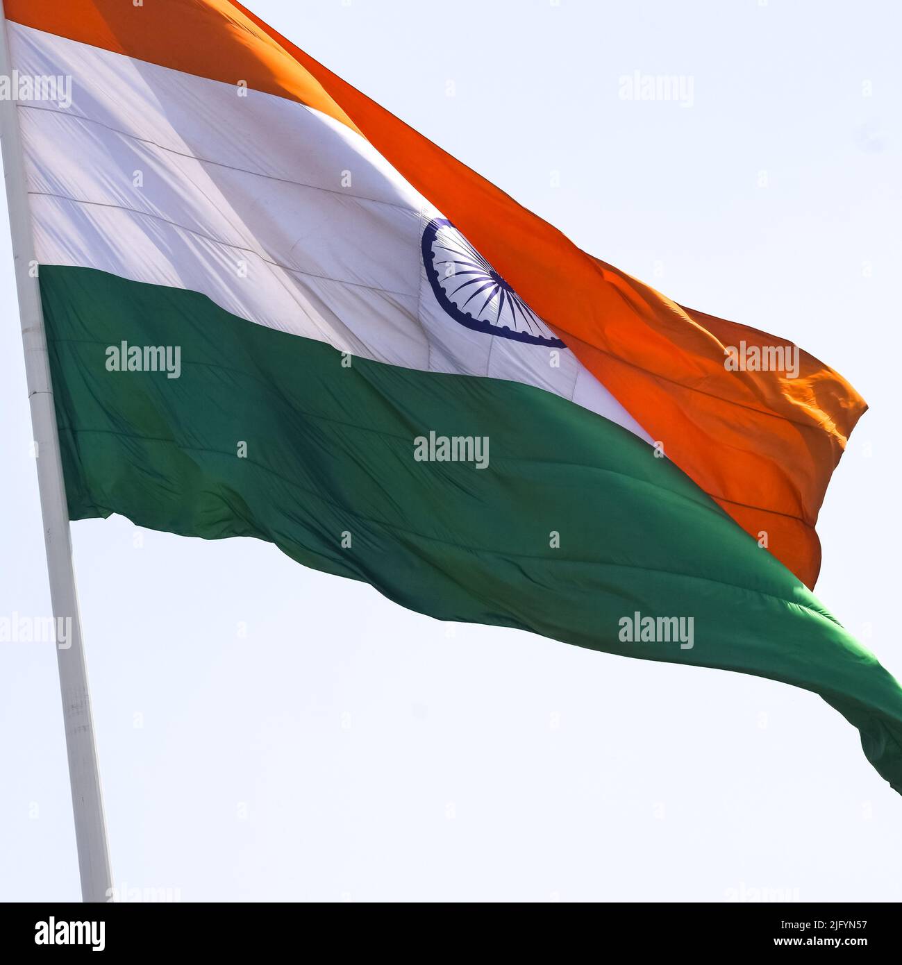 India flag flying high at Connaught Place with pride in blue sky, India flag fluttering, Indian ...
