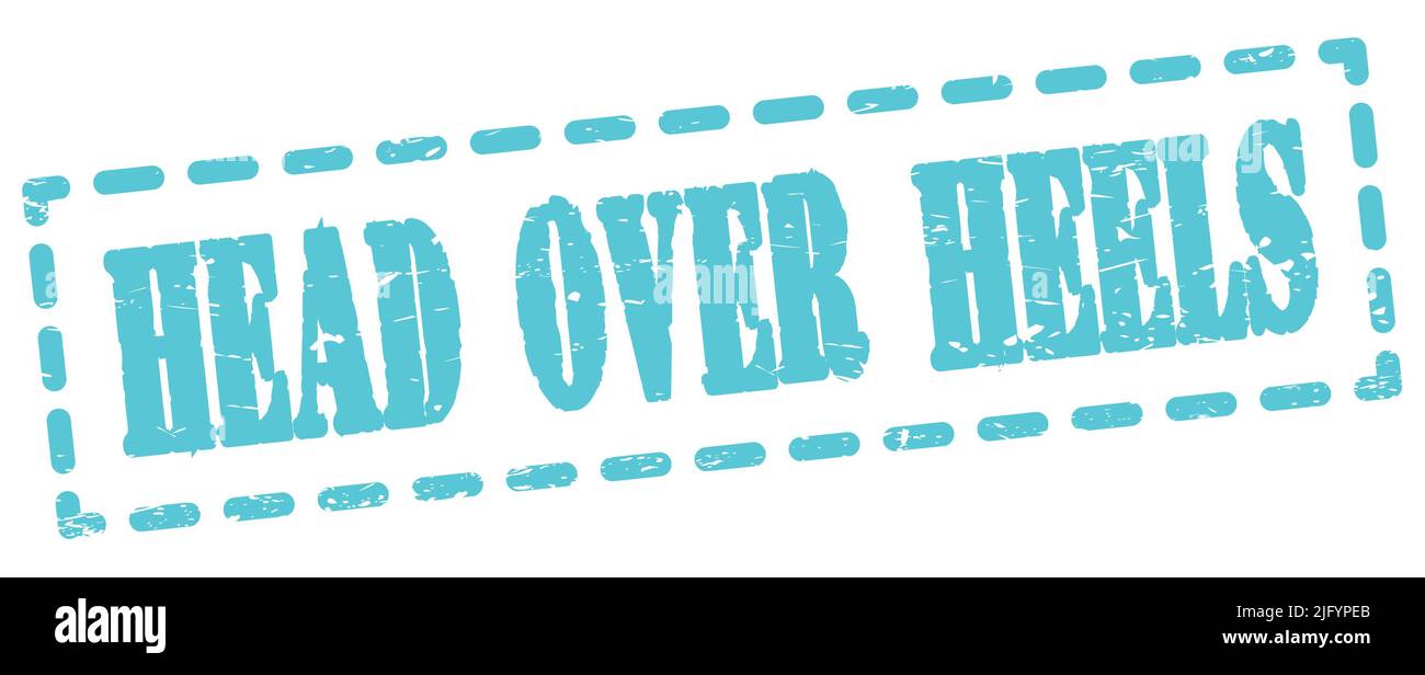 HEAD OVER HEELS text written on blue dash stamp sign Stock Photo - Alamy