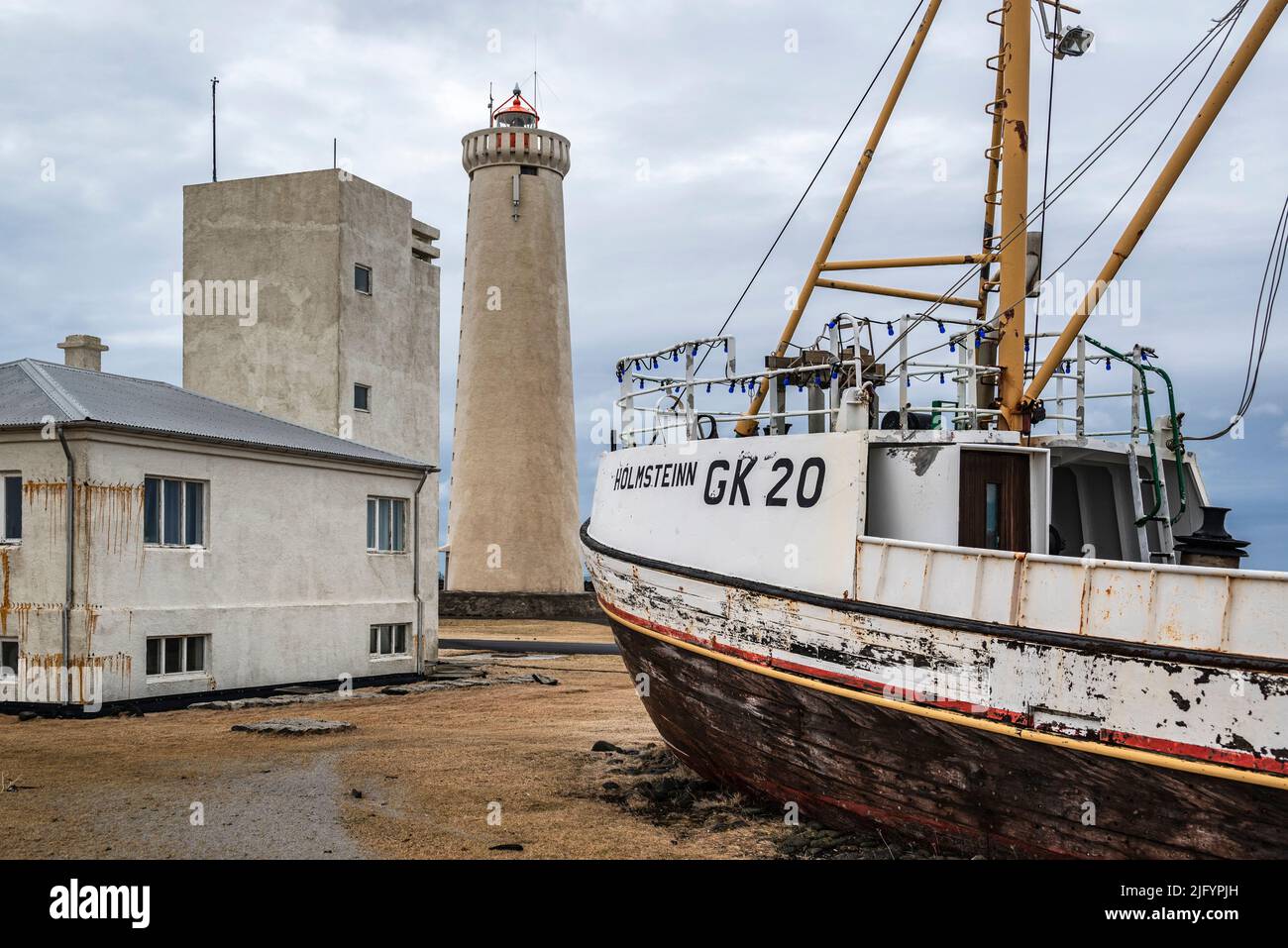 The new Garðskagi lighthouse and old shipwreck near the village of ...